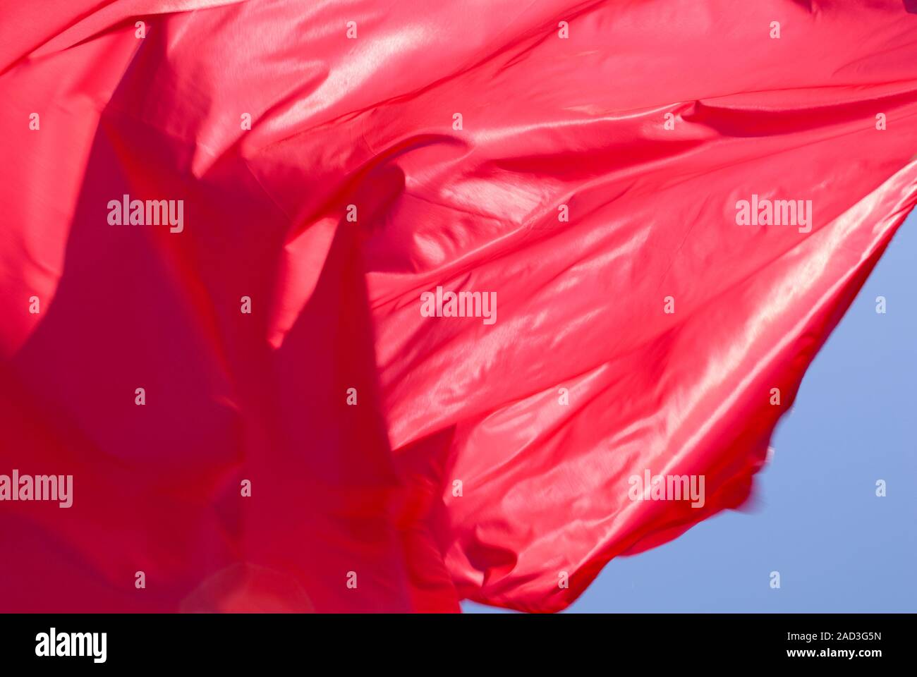 Fragment of red flag on a wind Stock Photo - Alamy