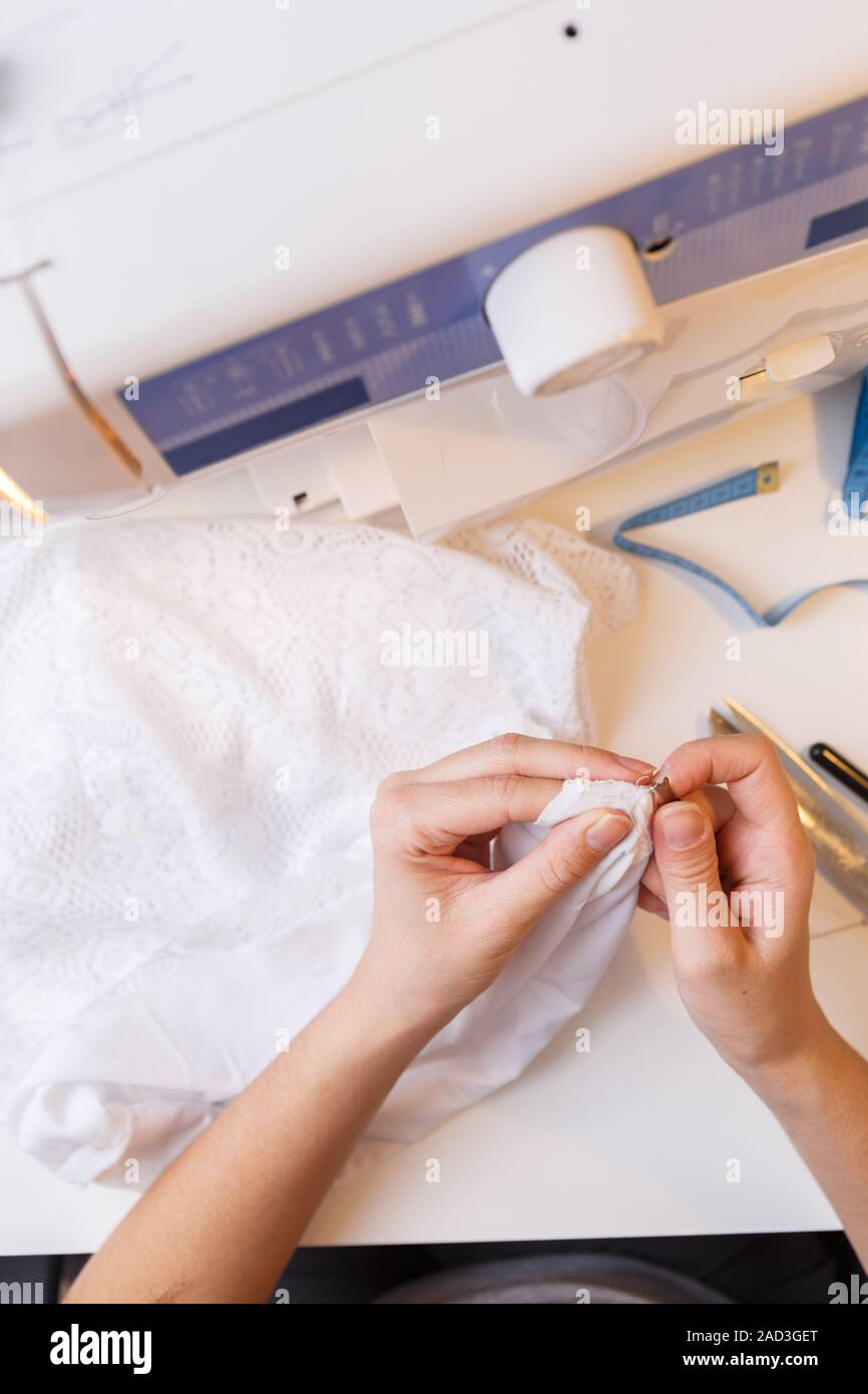 Girl in atelier unrips fabric Stock Photo - Alamy