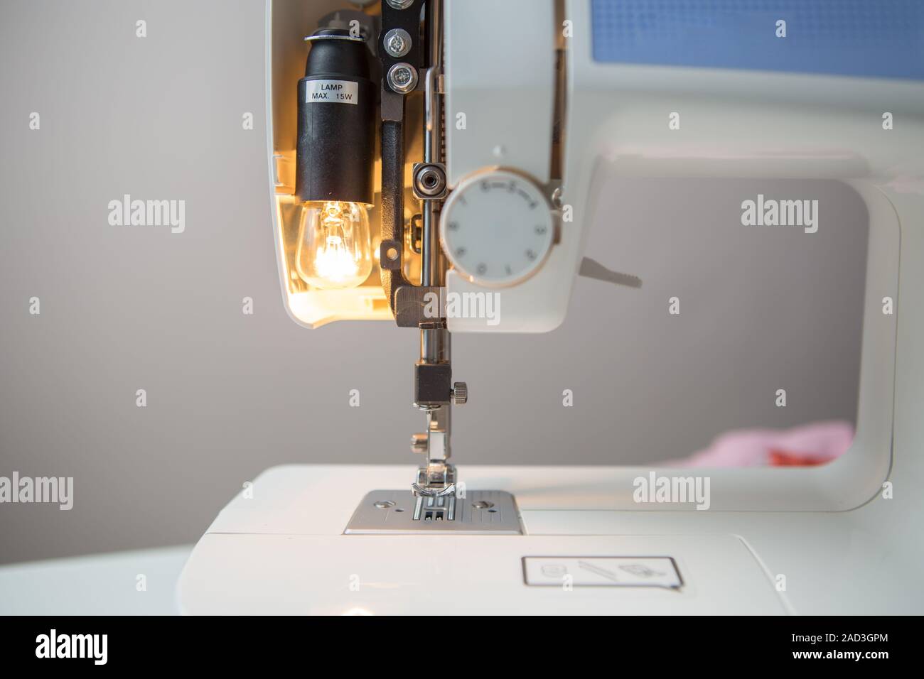 Sewing machine on gray background Stock Photo - Alamy