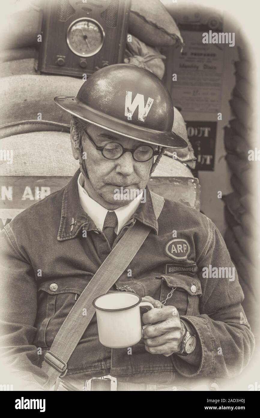 Black & white 1940s man as wartime ARP warden in W helmet (air raid ...