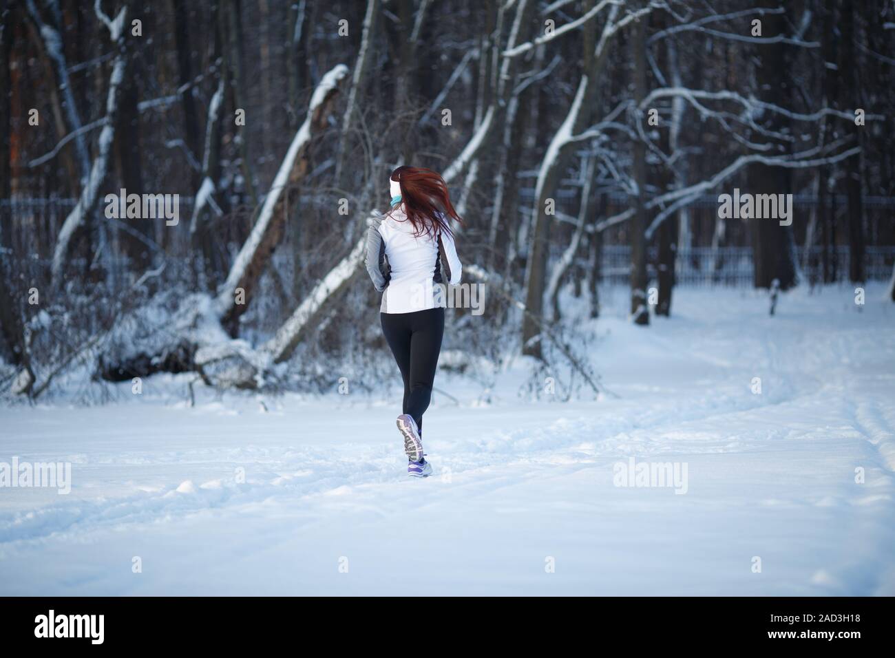 Young woman running among trees Stock Photo - Alamy
