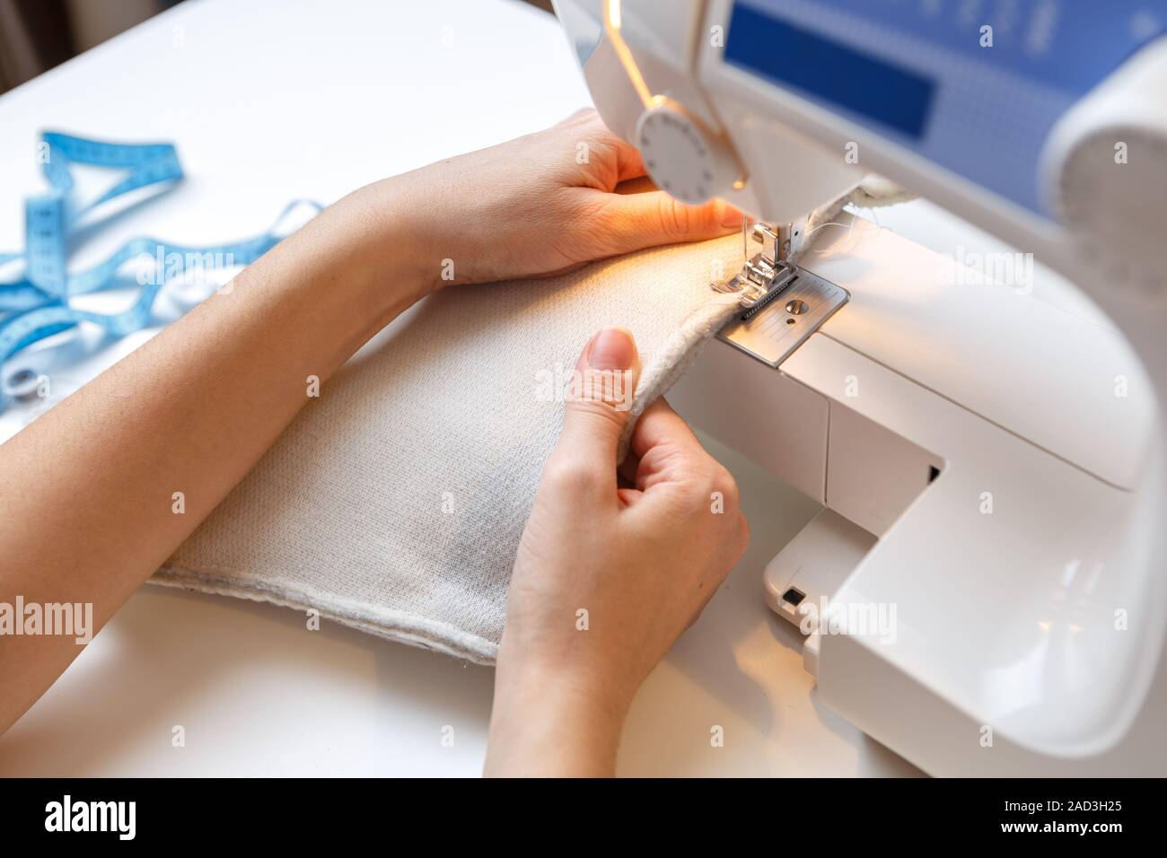Woman sews cloth on sewing hi-res stock photography and images - Alamy