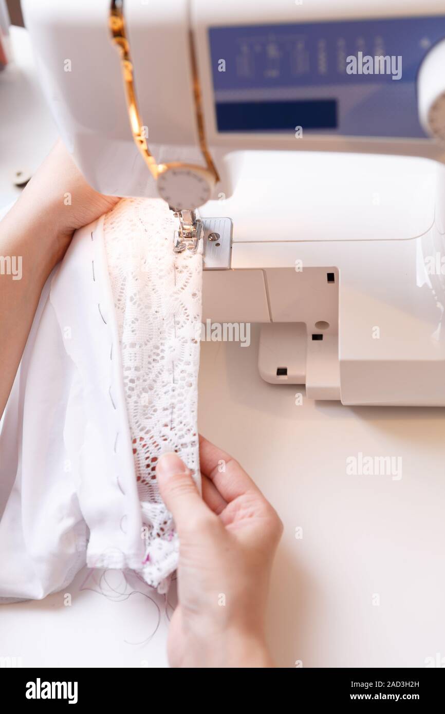 Photos of sewing-machine, hands girl Stock Photo - Alamy
