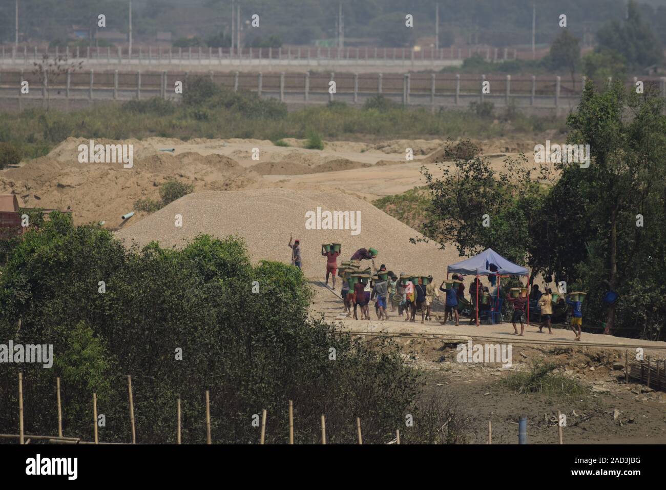Human mules unloading a barge of gravel aggregate in Yangon, Rangoon ...