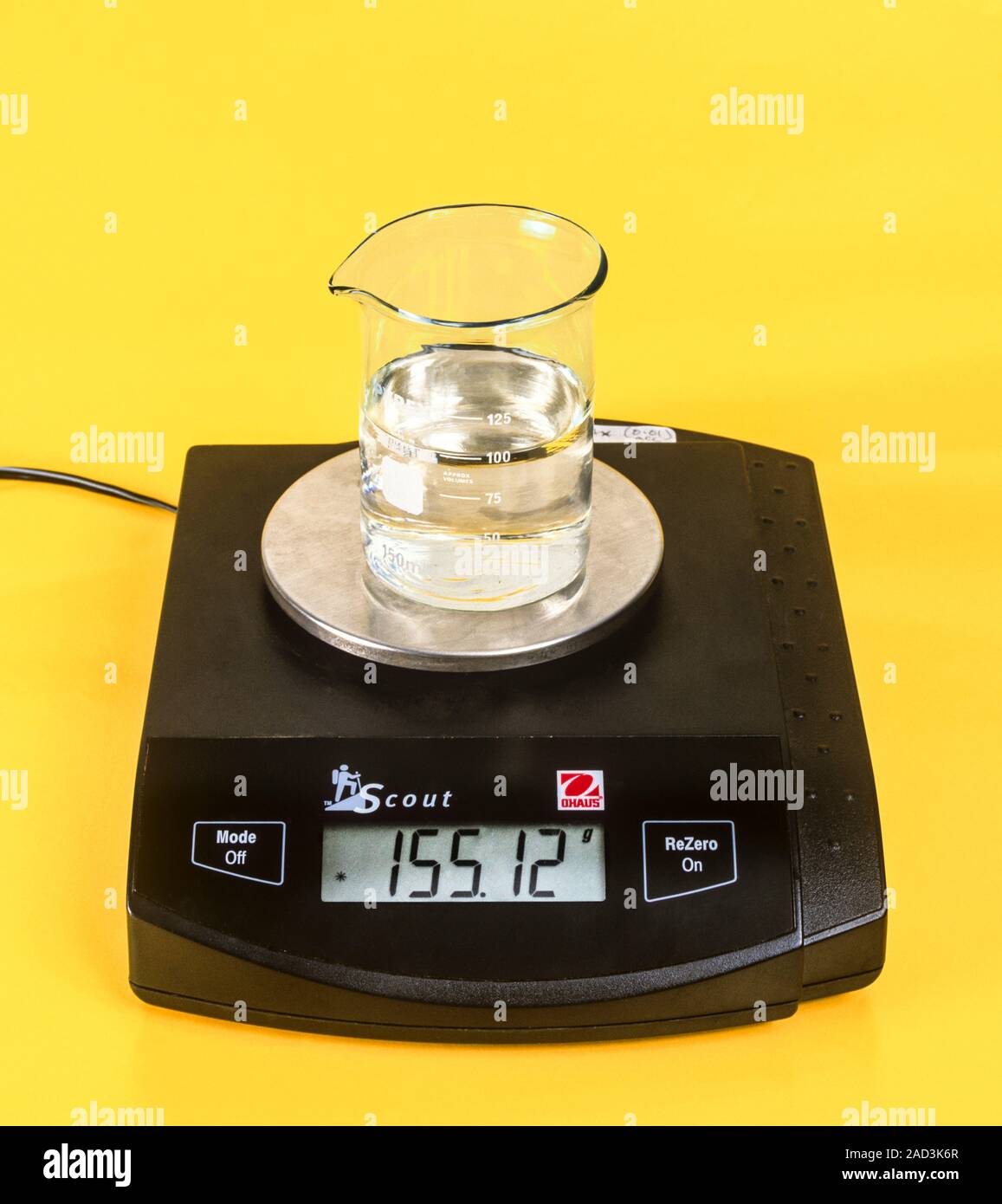 Digital scales. Digital balance being used to measure the weight of a ...