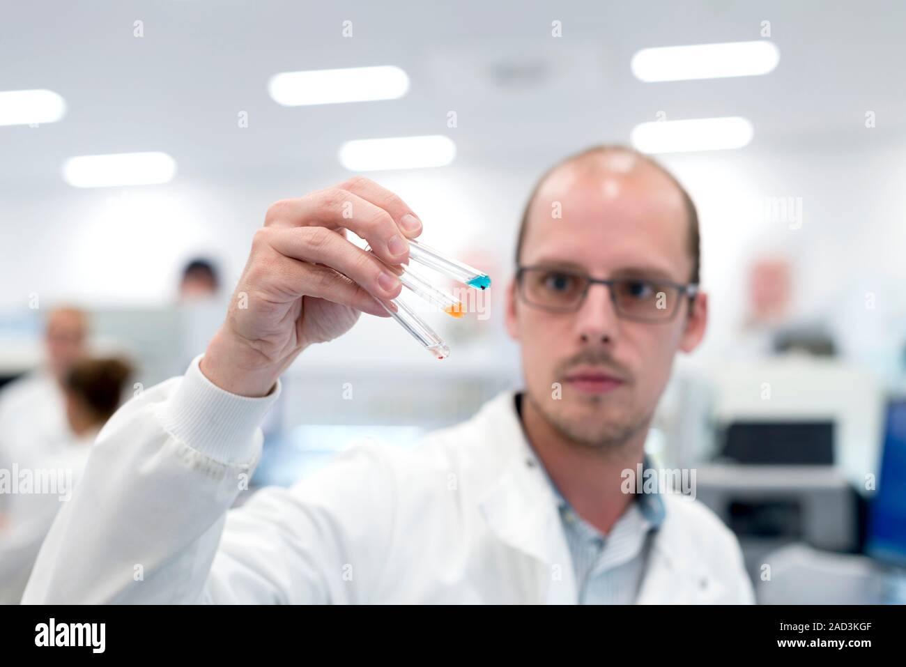 Blood group analysis. Biochemist analysing blood samples to determine a ...