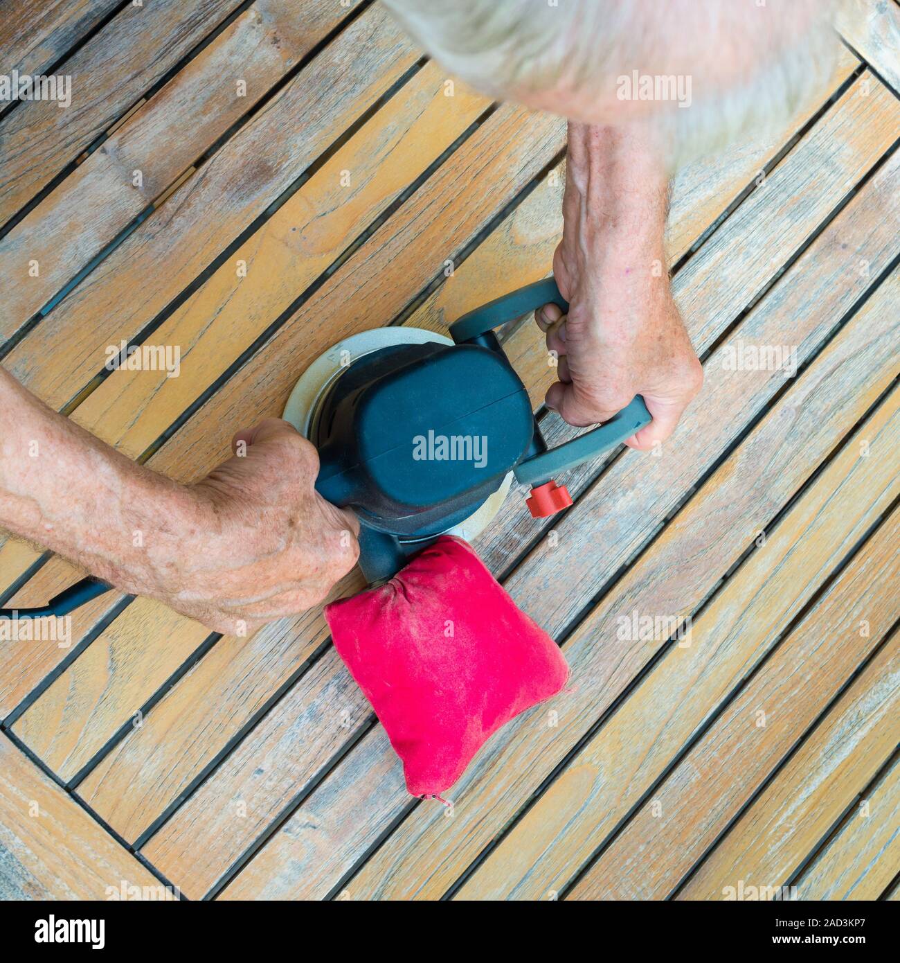 Close-up of old carpenter's hands working with electric sander Stock ...