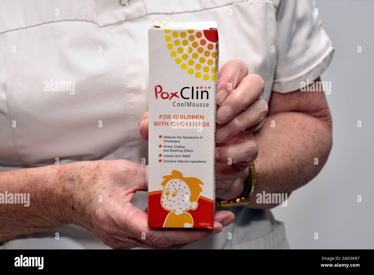 Chickenpox treatment. Person holding a box containing Pox Clin mousse ...