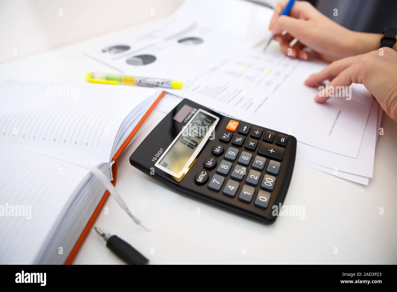 Accountant at table with papers Stock Photo - Alamy