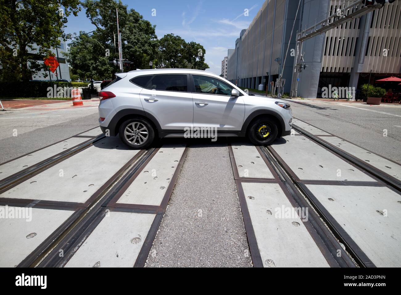 car driving across railroad tracks crossing west central boulevard ...