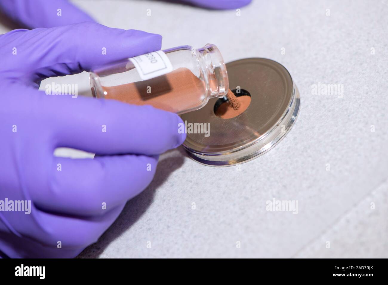 Forensic evidence analysis. Forensic scientist preparing a sample of ...