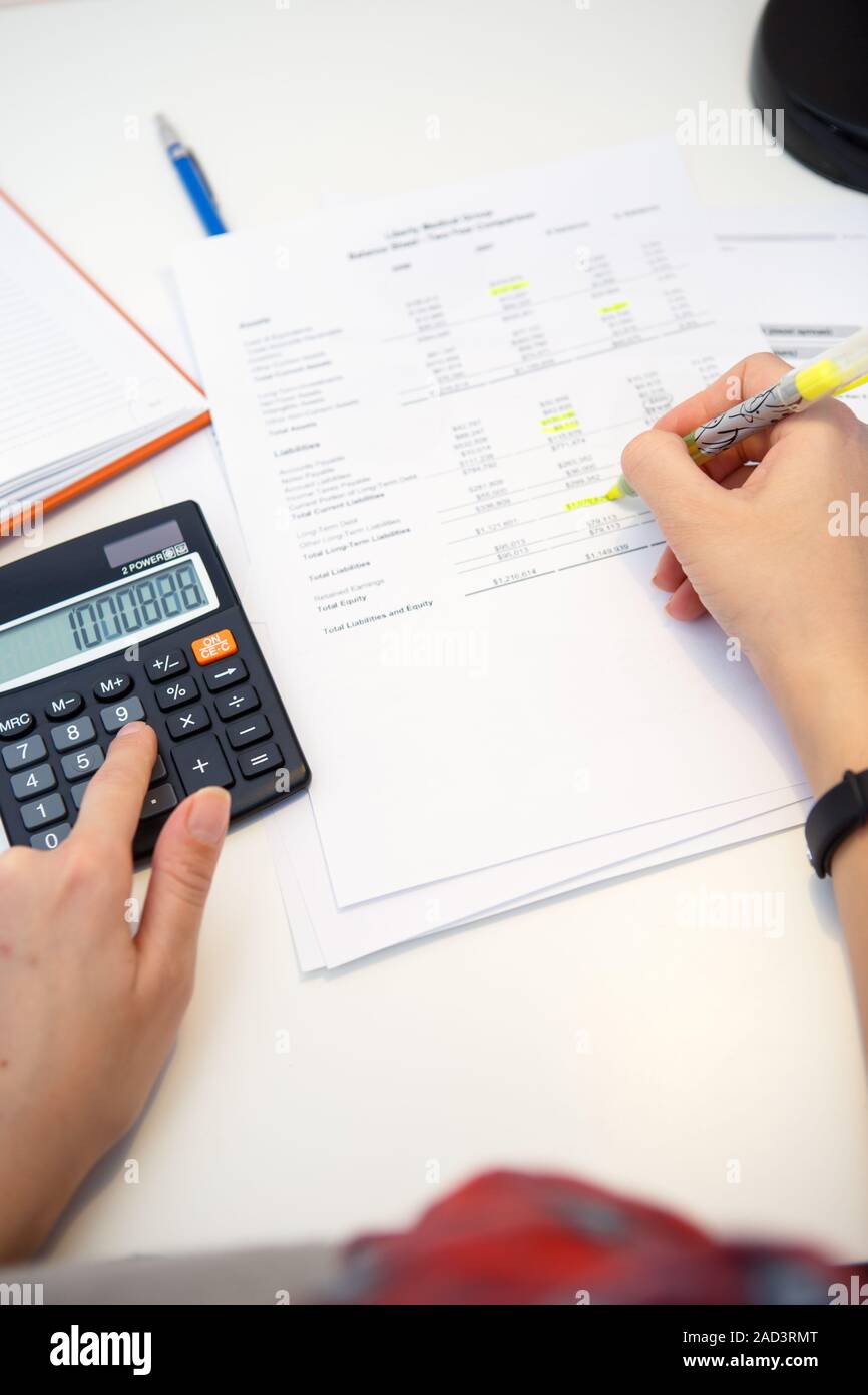 Young woman working with papers Stock Photo - Alamy