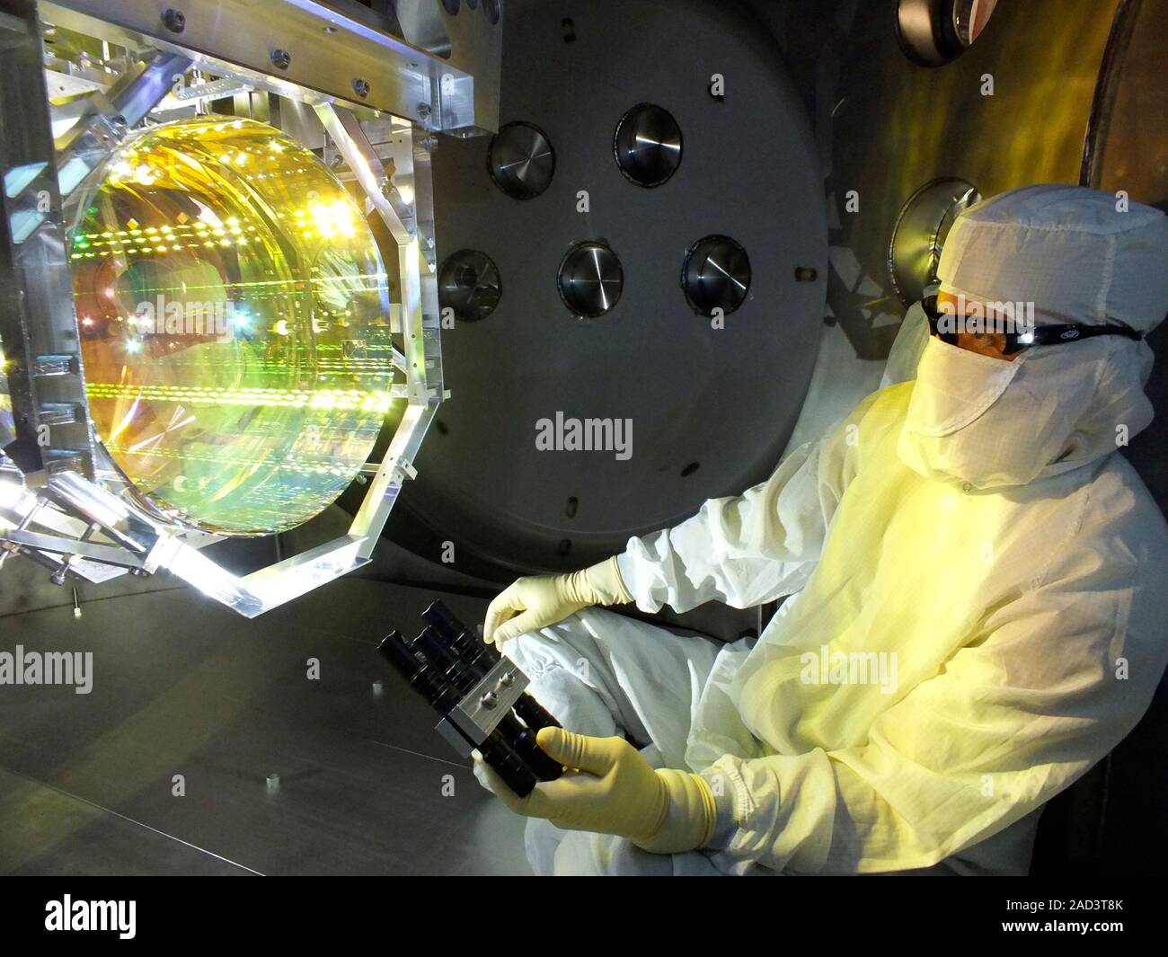 Ligo Gravitational Wave Detector Optics Researcher Inspecting The Optics Mirror Yellow Of