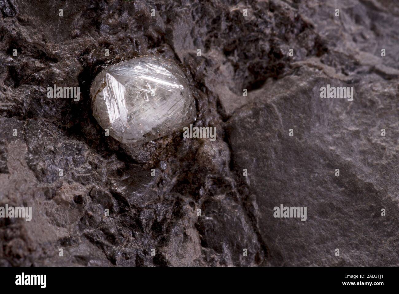 Diamond in host rock. Close-up of a diamond (upper left) still embedded ...