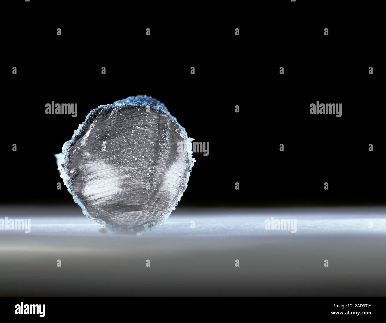 Lithium. Sample of freshly cut lithium. Lithium is a highly reactive ...