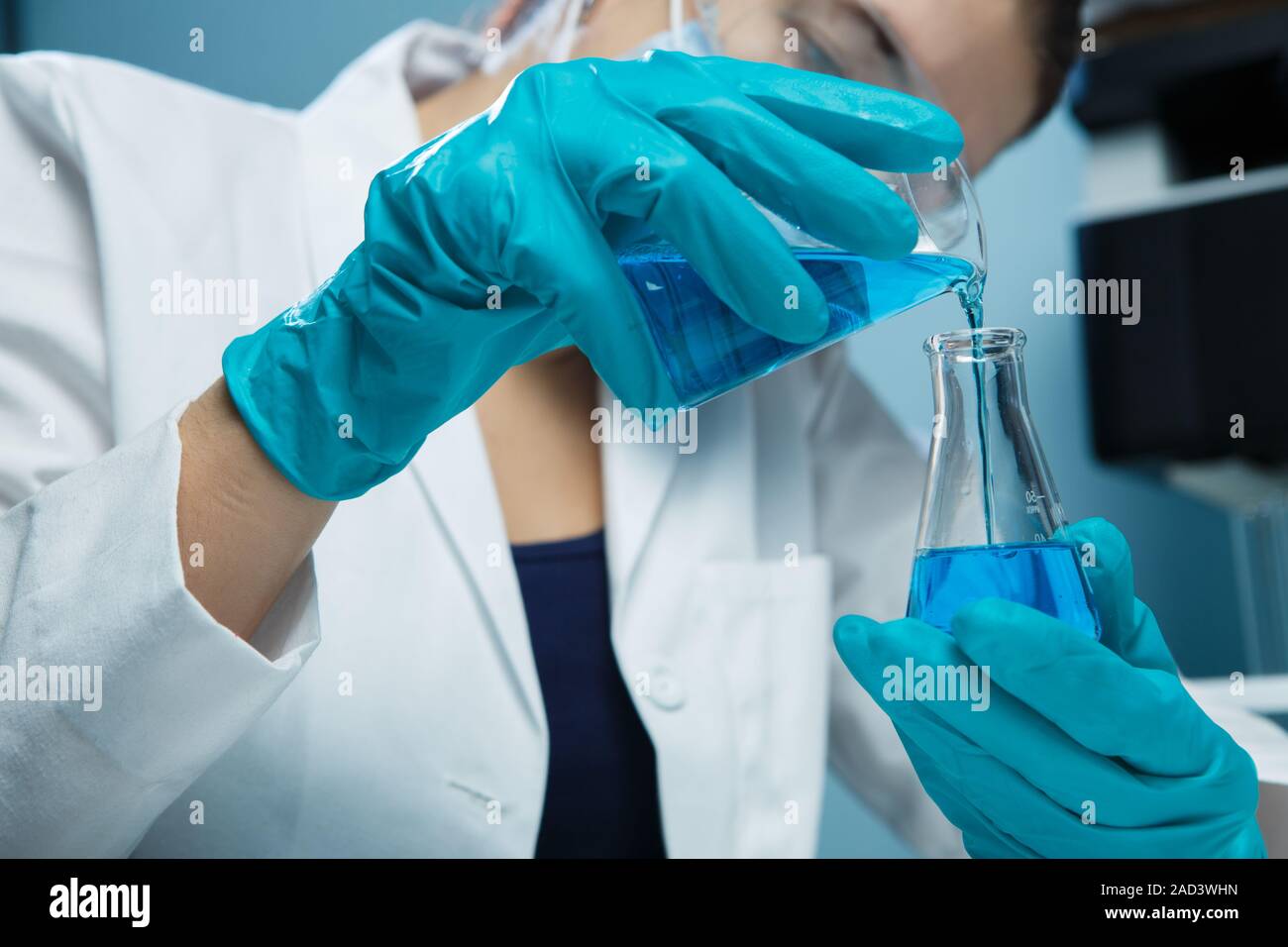 Laboratorian conducted experiments with flask Stock Photo - Alamy