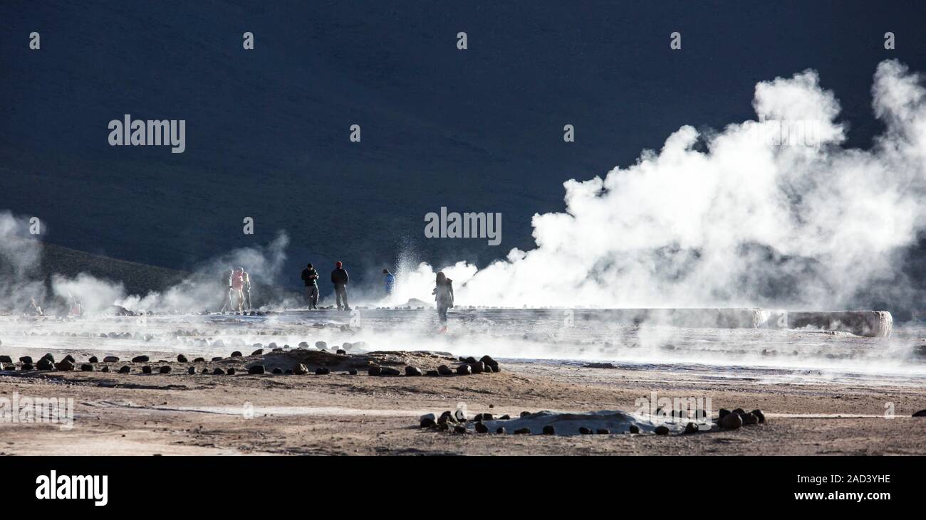 Geyser field. Tourists viewing the steam rising from hot pools in the ...