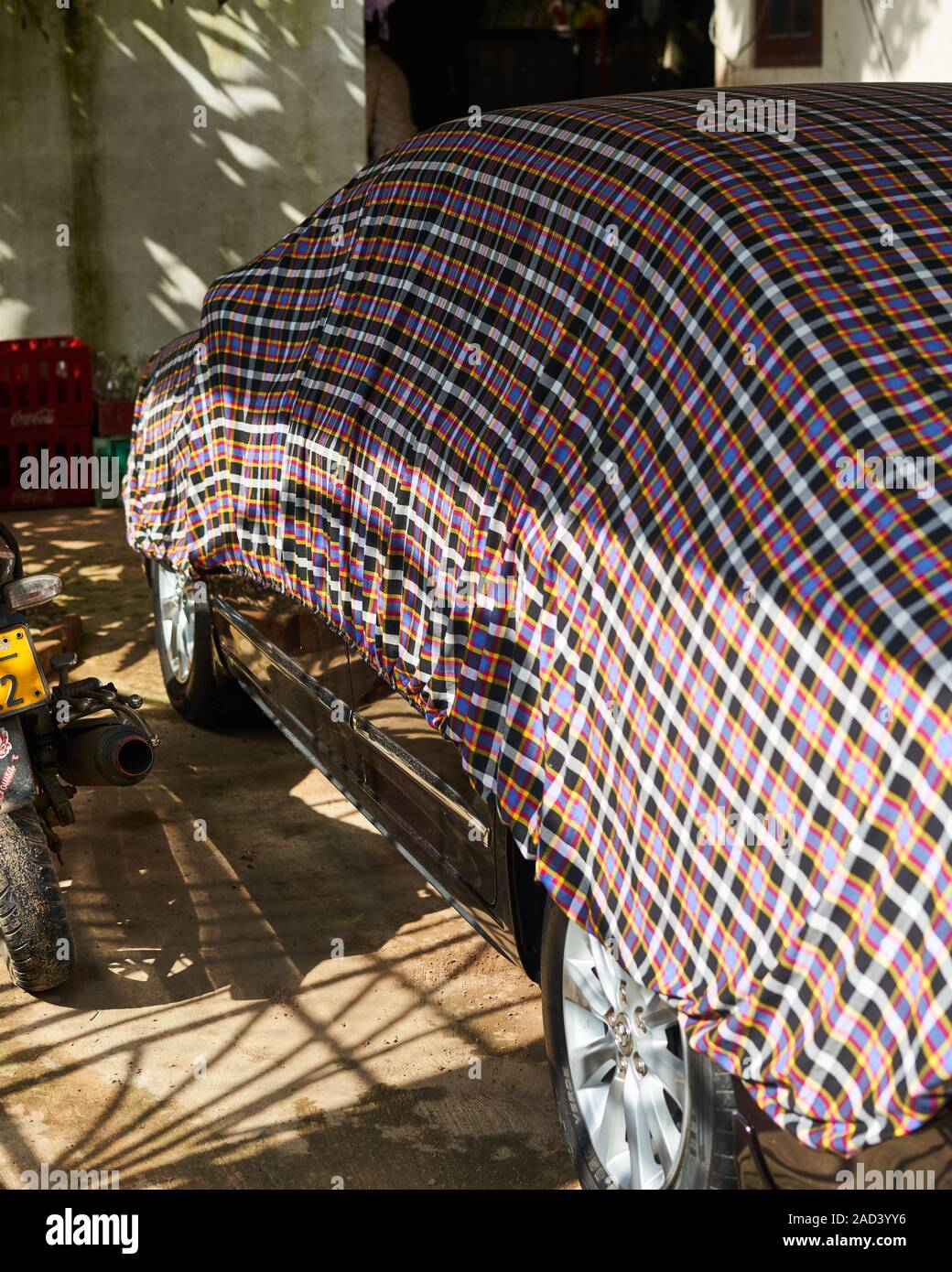 A covered car with dappled light Stock Photo - Alamy