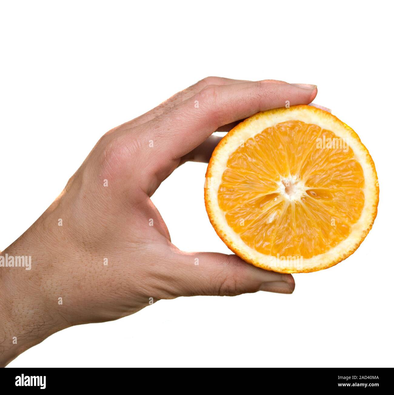 Hand holding half of orange Stock Photo - Alamy