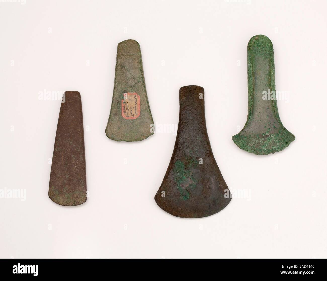 Four flat metal celts showing the progression that generally lead from ...
