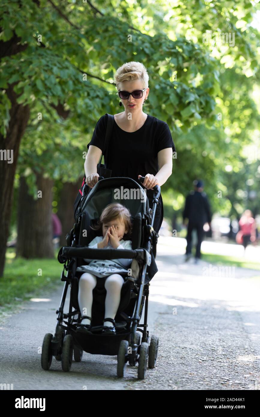 mother pushed her baby daughter in a stroller Stock Photo - Alamy