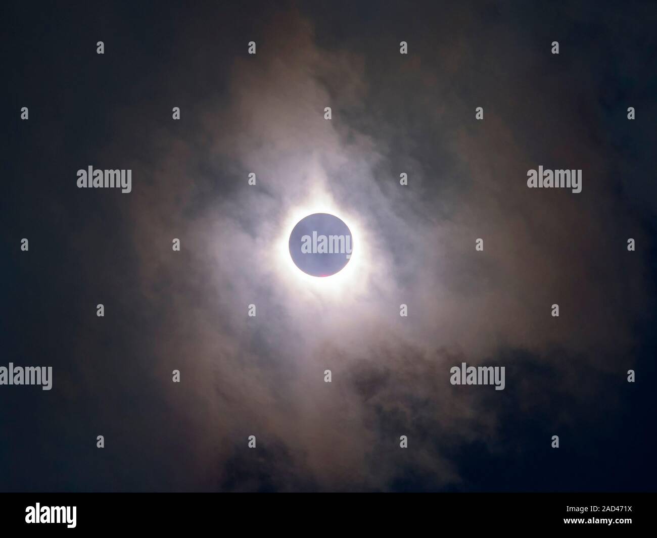 Total solar eclipse seen through clouds. Total solar eclipses occur when the Moon passes ...