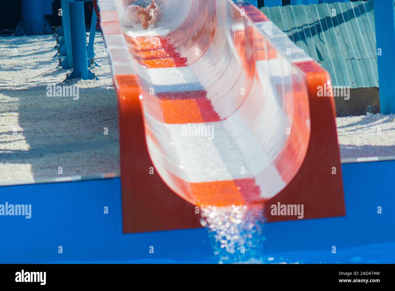 Spray of water rolls off a water slide in an aqua park. Water ...
