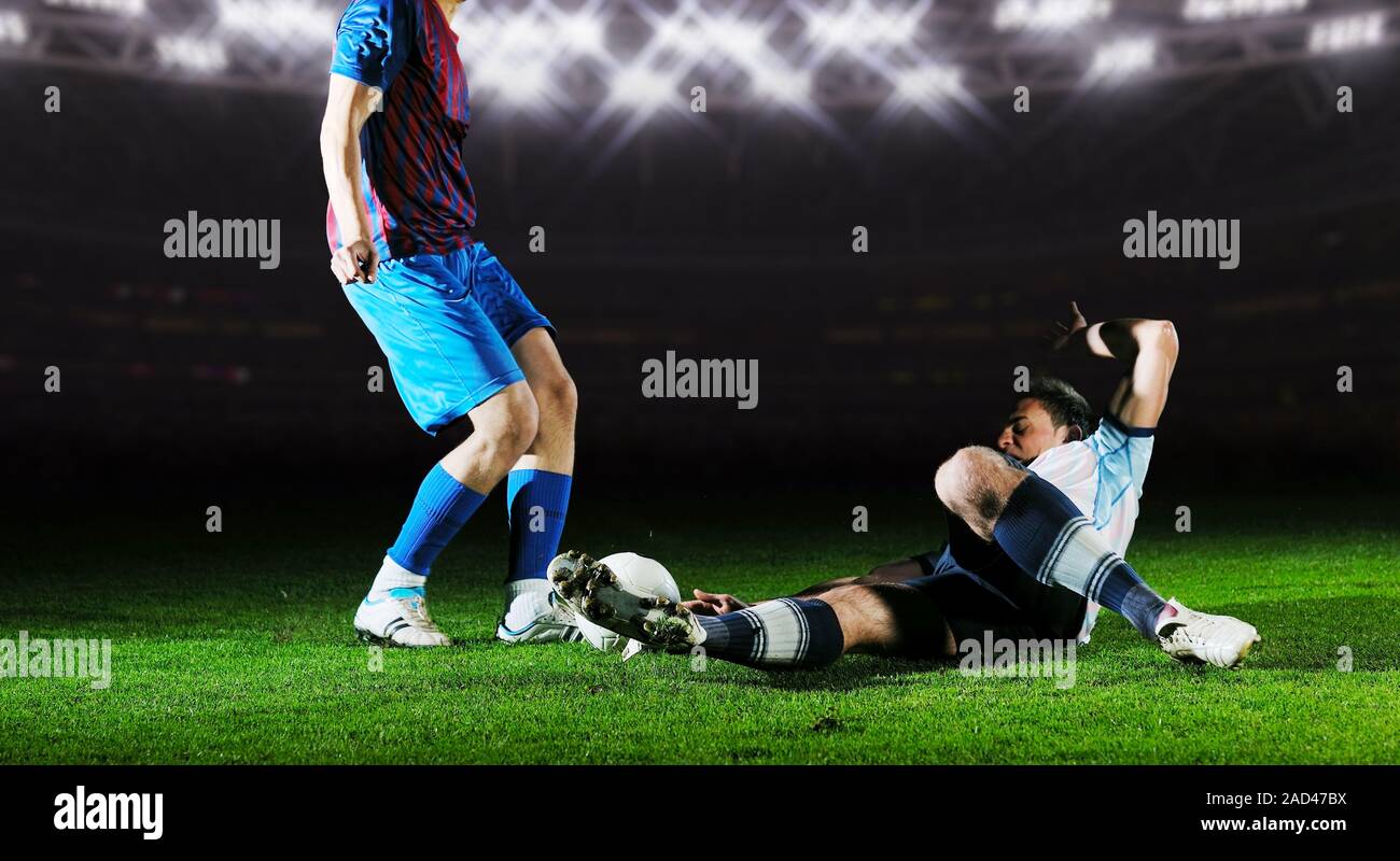 football players in competition for the ball Stock Photo - Alamy