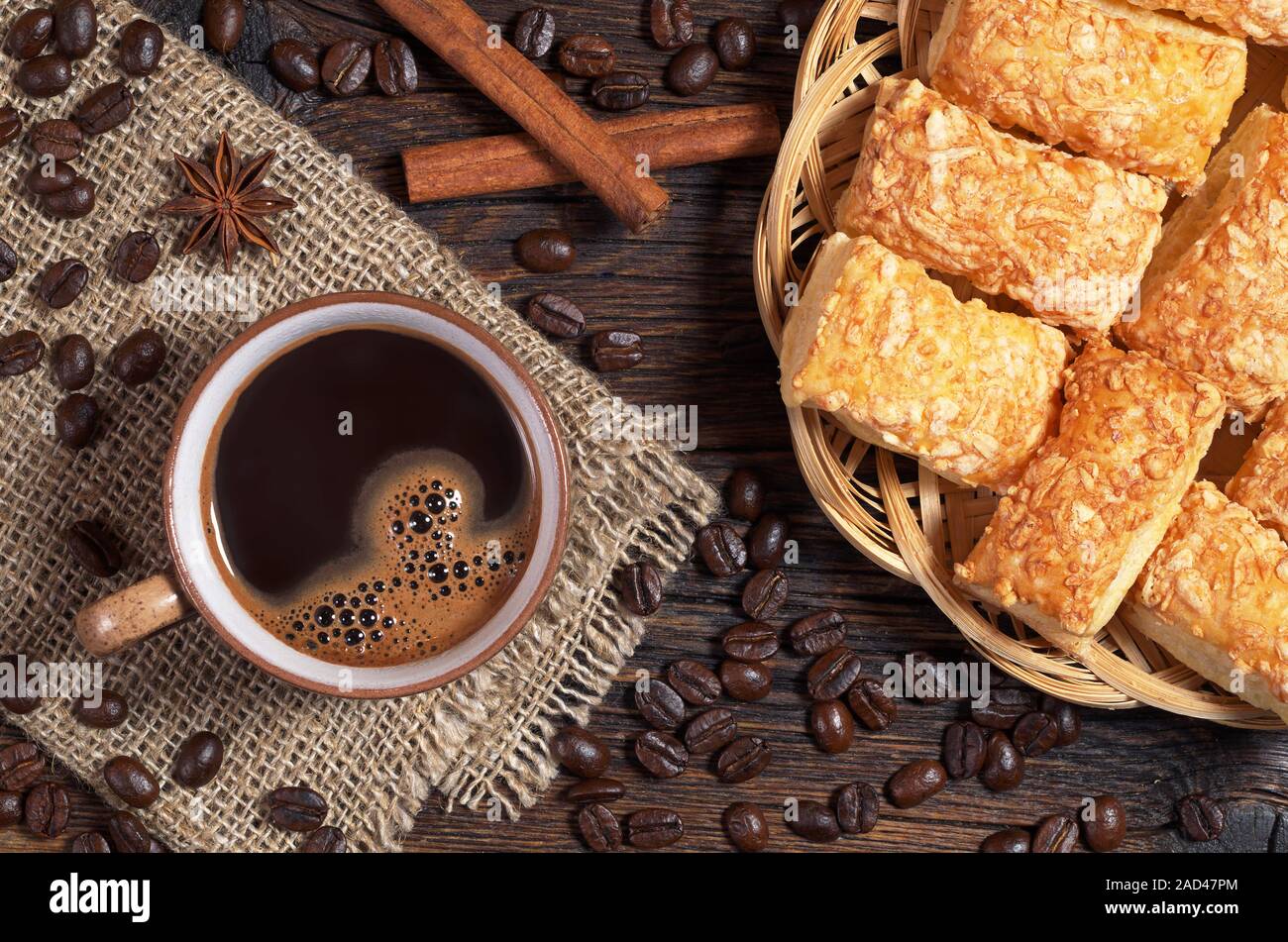 Coffee cup and puff cookies with cheese on old wooden table, top view ...