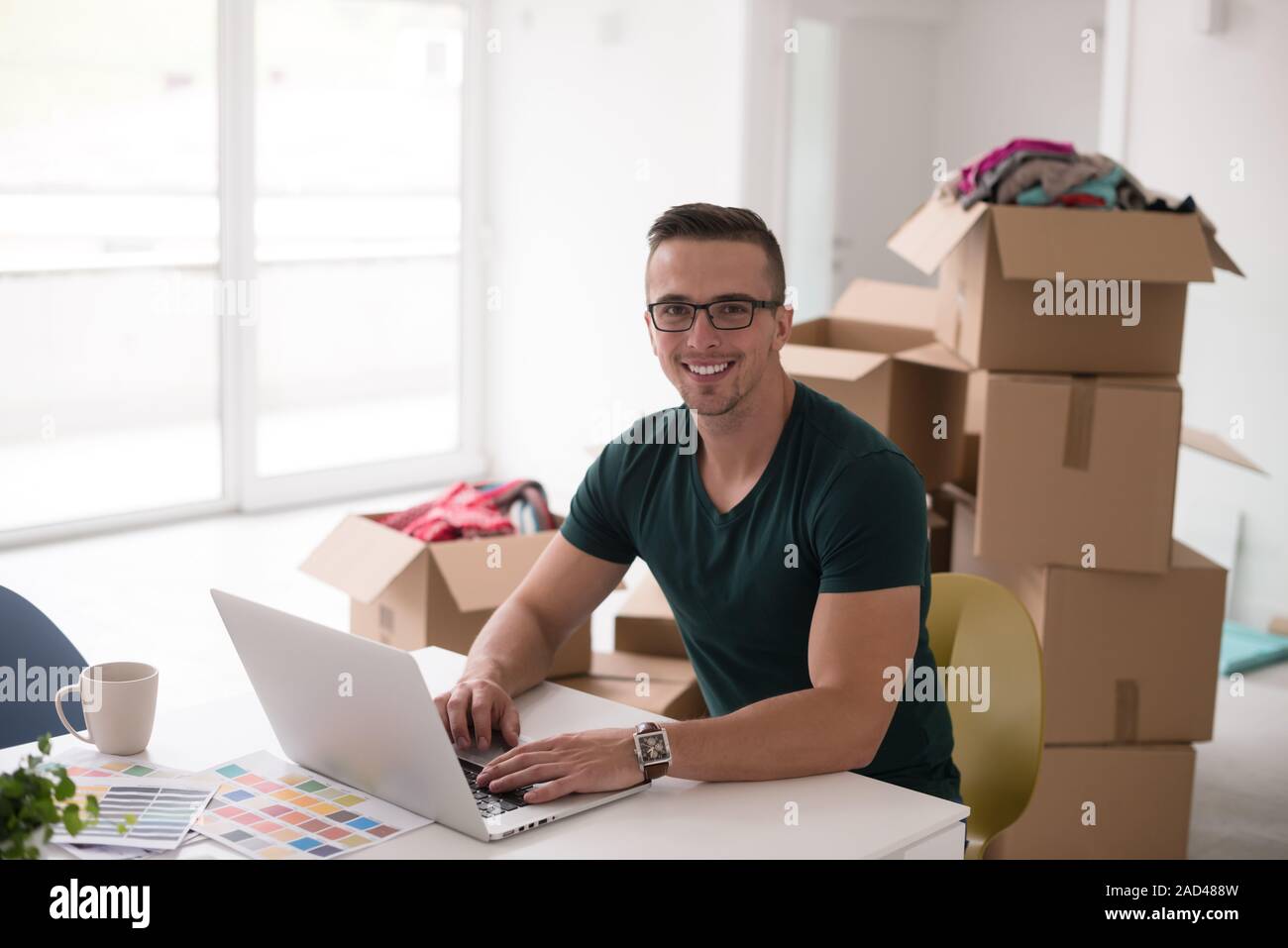 Young man moving in a new home Stock Photo - Alamy
