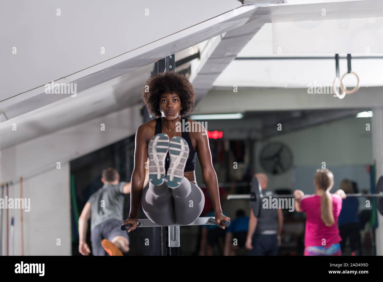 black woman doing parallel bars Exercise Stock Photo - Alamy