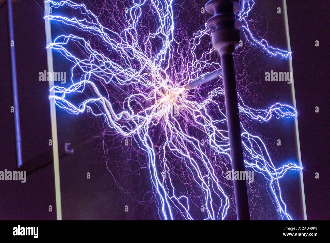High voltage discharge between electrodes separated by a glass sheet. A ...