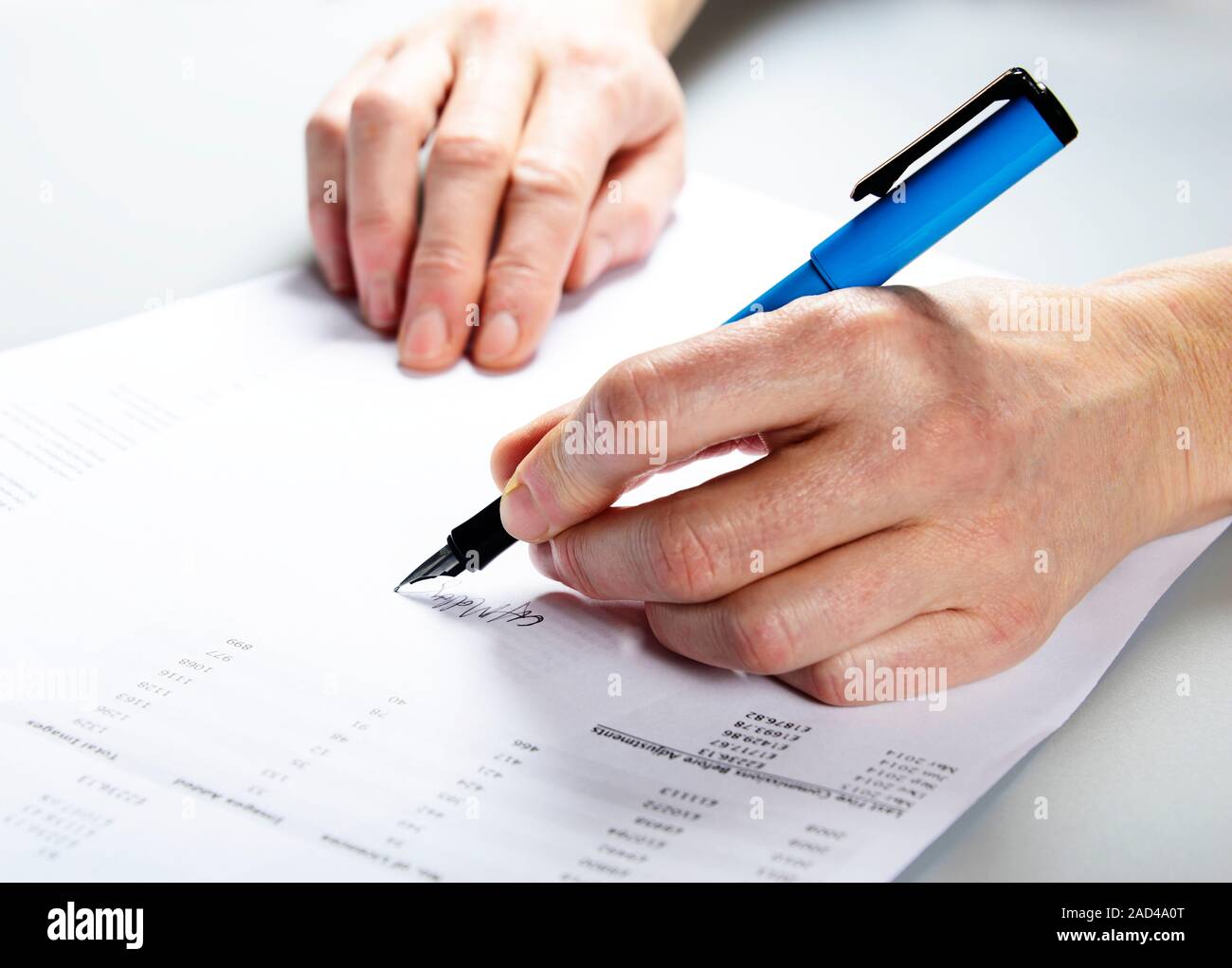 Left-handed person signing papers Stock Photo - Alamy