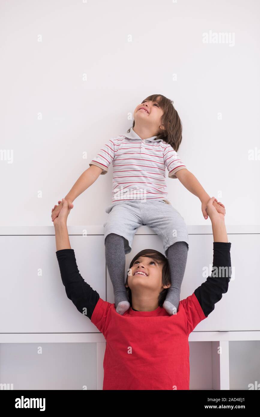young boys posing line up piggyback Stock Photo - Alamy