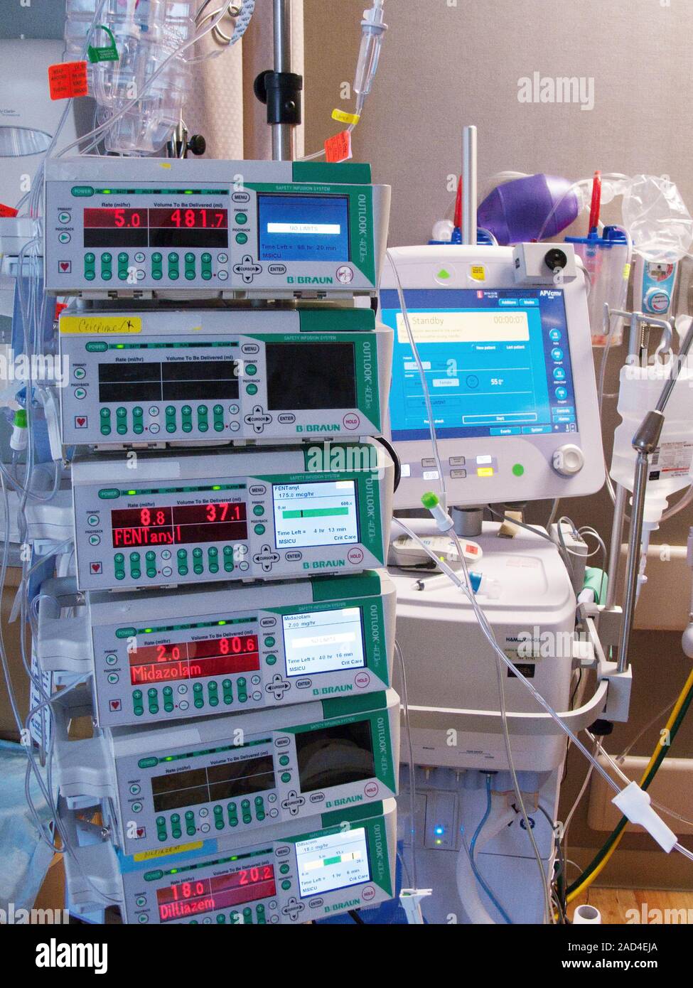 Hospital intensive care unit. Infusion pumps (left) and ventilator ...