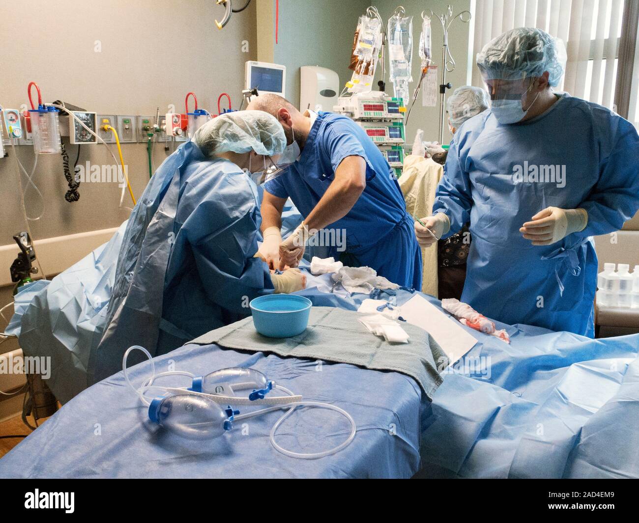 Emergency abdominal surgery. Surgical team performing an emergency ...
