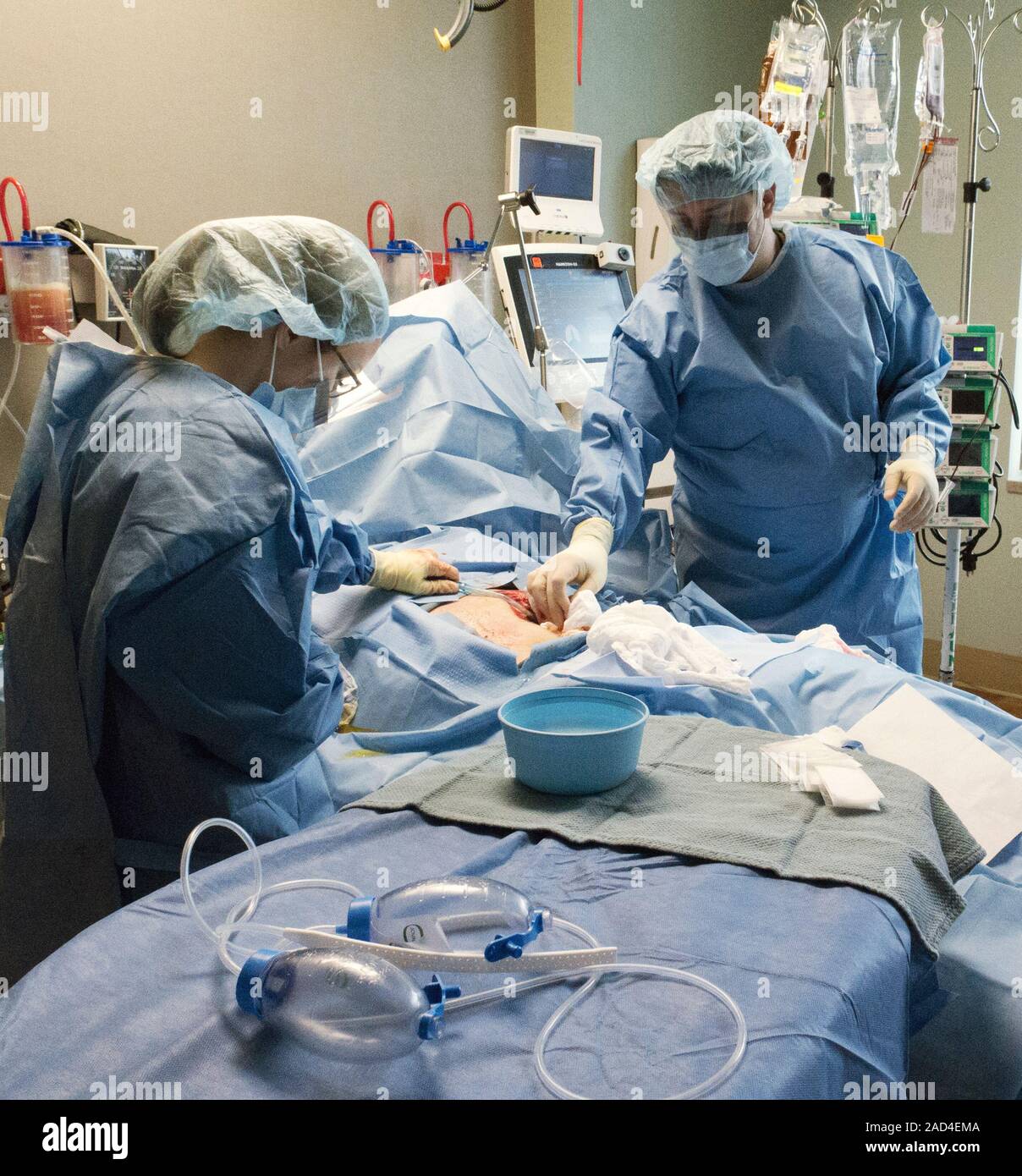 Emergency abdominal surgery. Surgical team performing an emergency ...