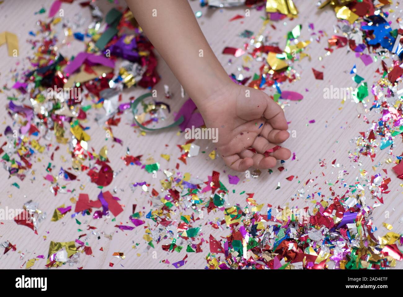 Children's hand with confetti in background Stock Photo - Alamy