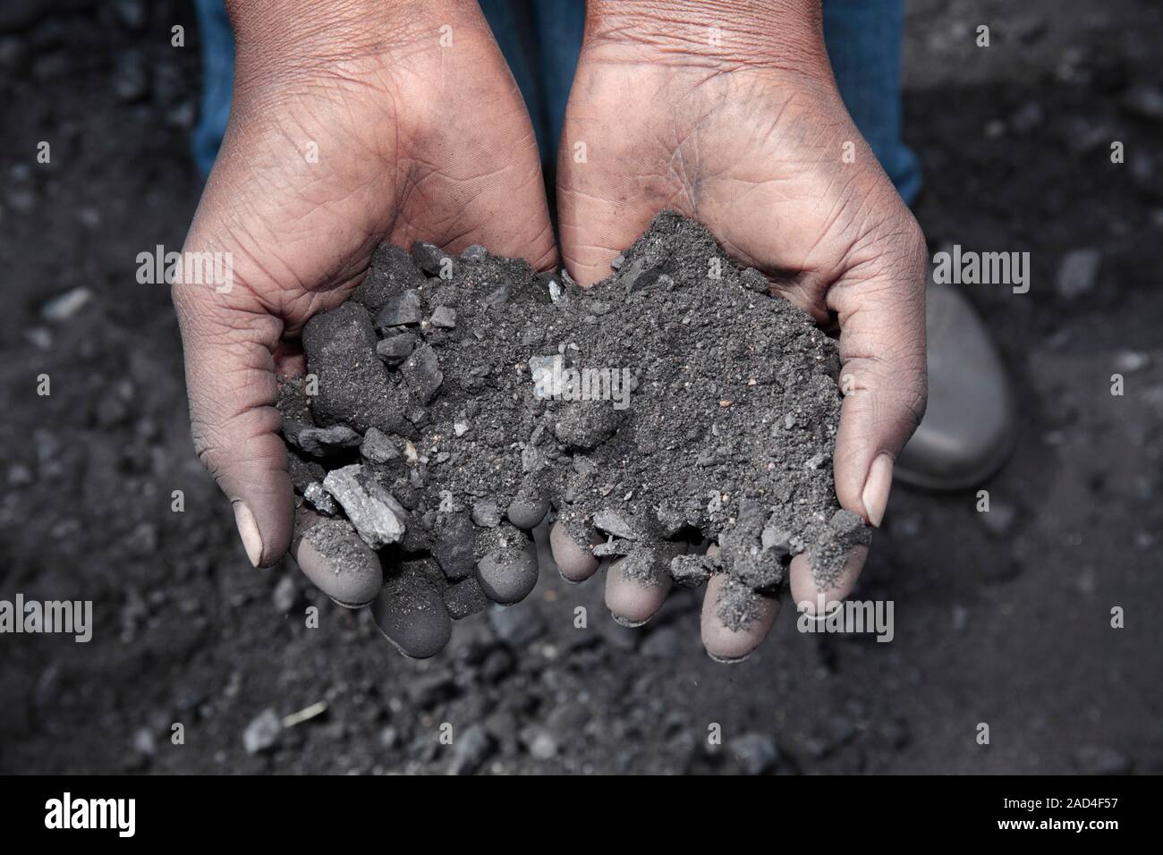 Scavenging for fuel. Local South African boy collecting waste coal from ...