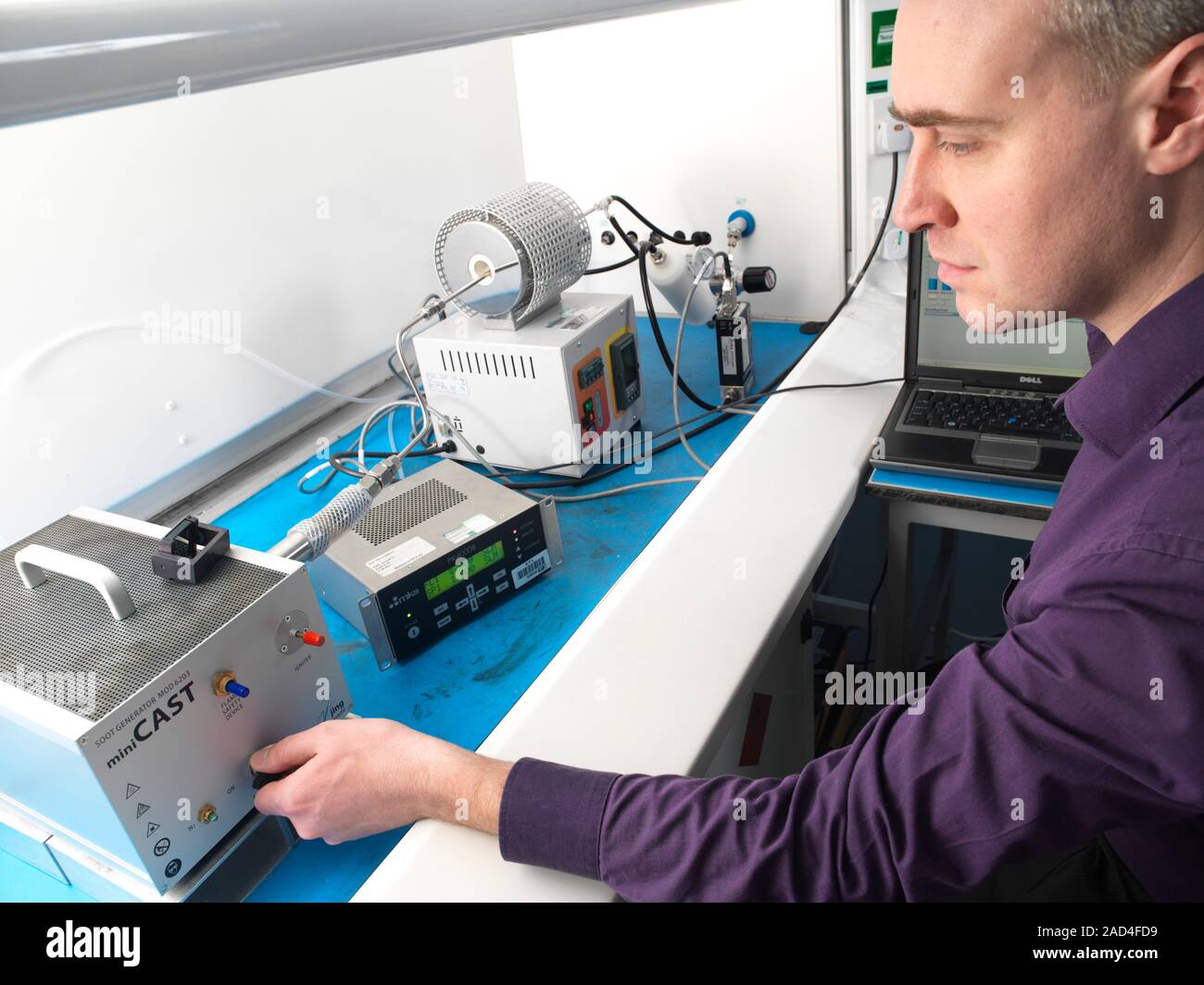 Soot nanoparticle generator. Researcher using a soot nanoparticle ...
