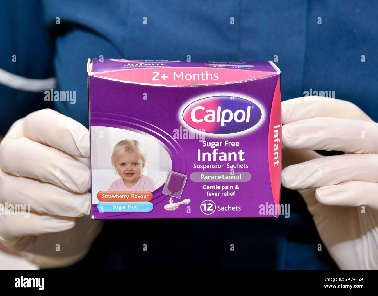 Sugar free Calpol. Nurse holding a box containing sachets of sugar free ...