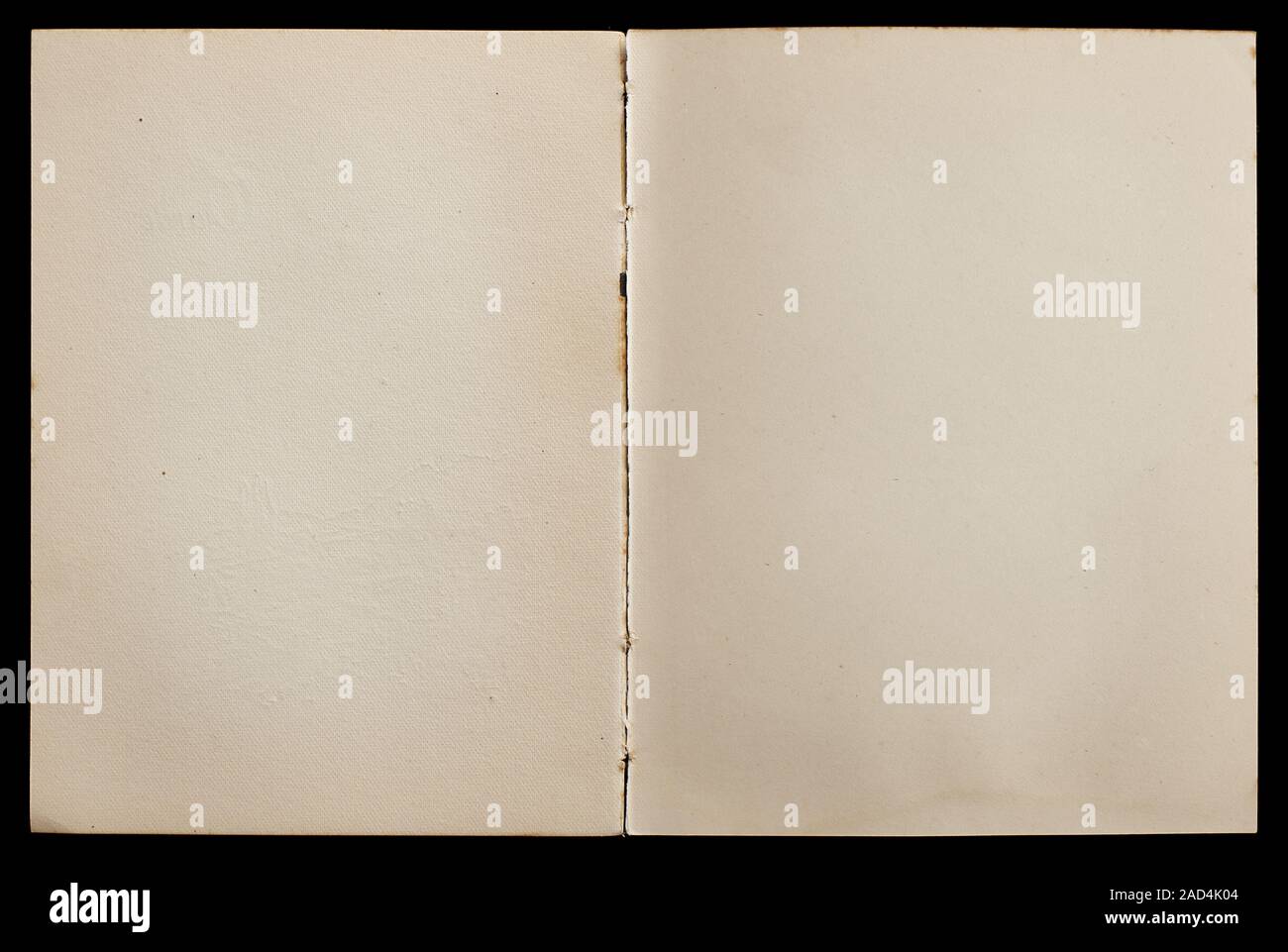 Antique book unfolded showing textured pages isolated on black ...