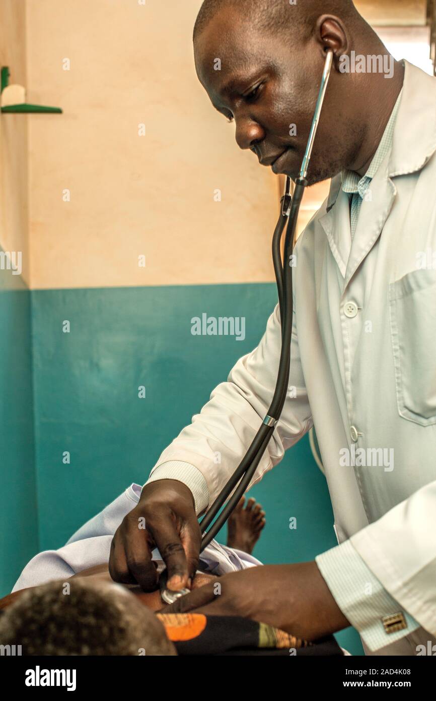 Hospital examination. Hospital doctor examining a patient with a ...