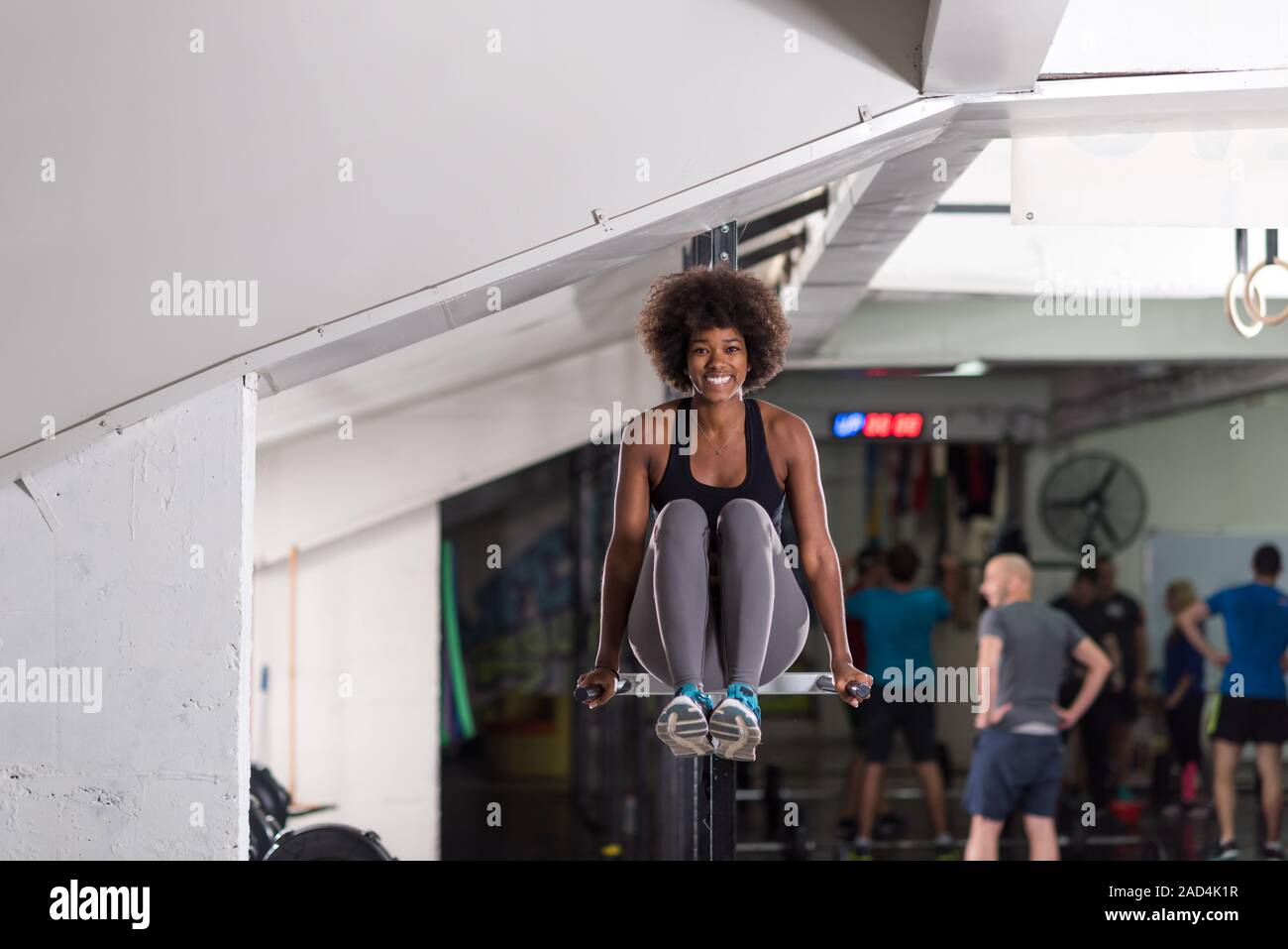 black woman doing parallel bars Exercise Stock Photo - Alamy