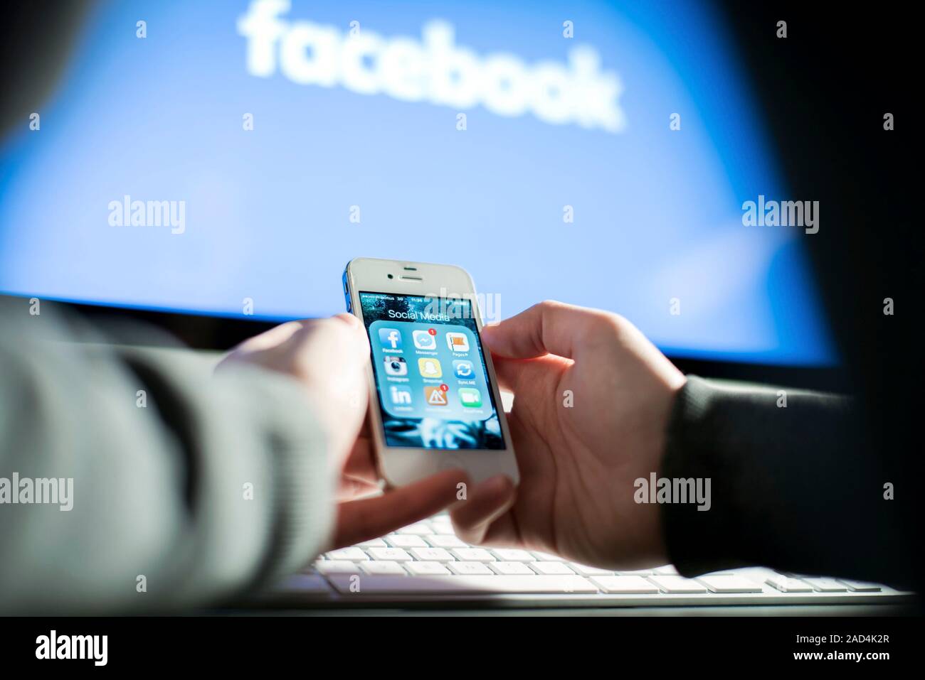 Social media and smart phone, with a Facebook logo displayed in the ...