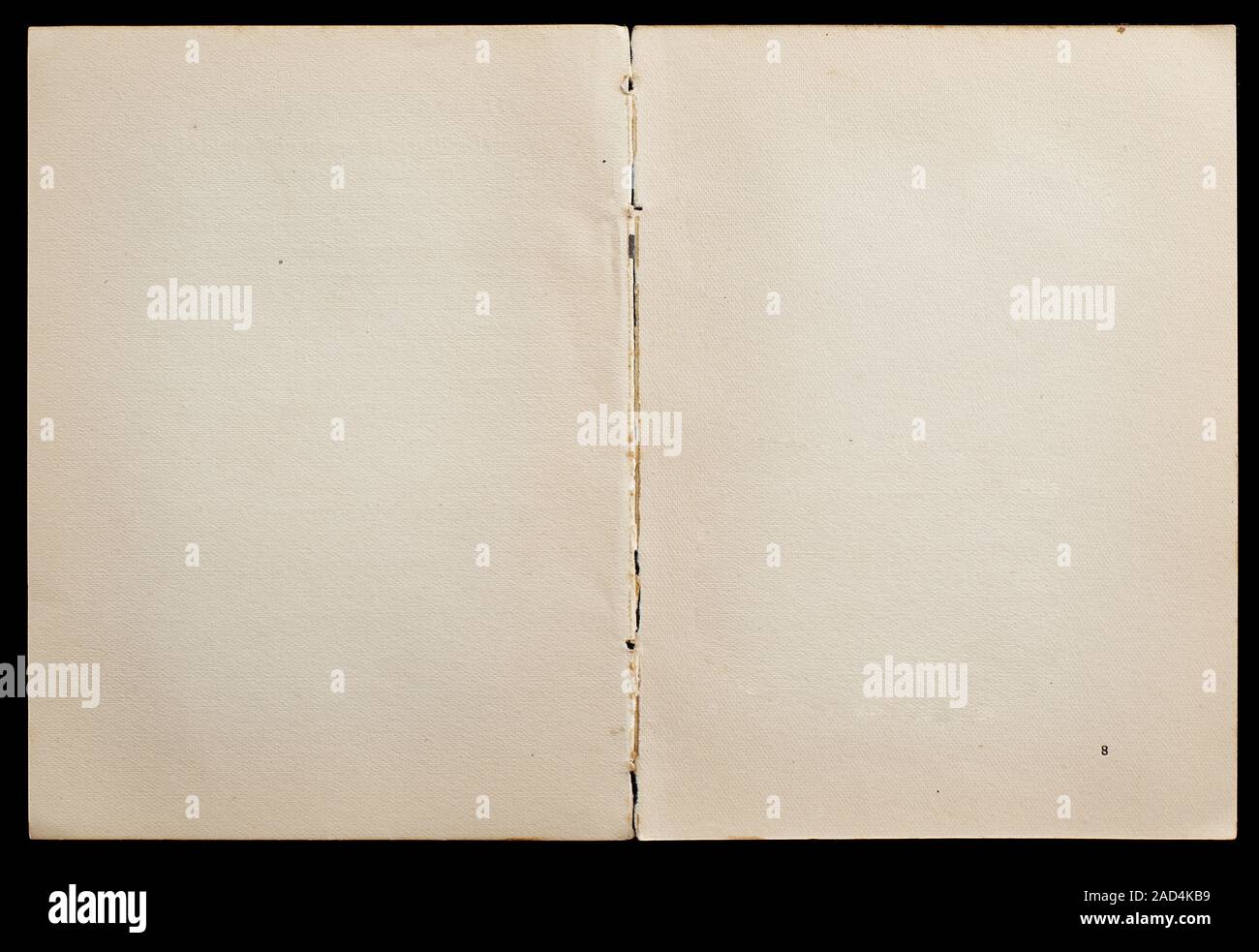 Antique book unfolded showing textured pages isolated on black ...