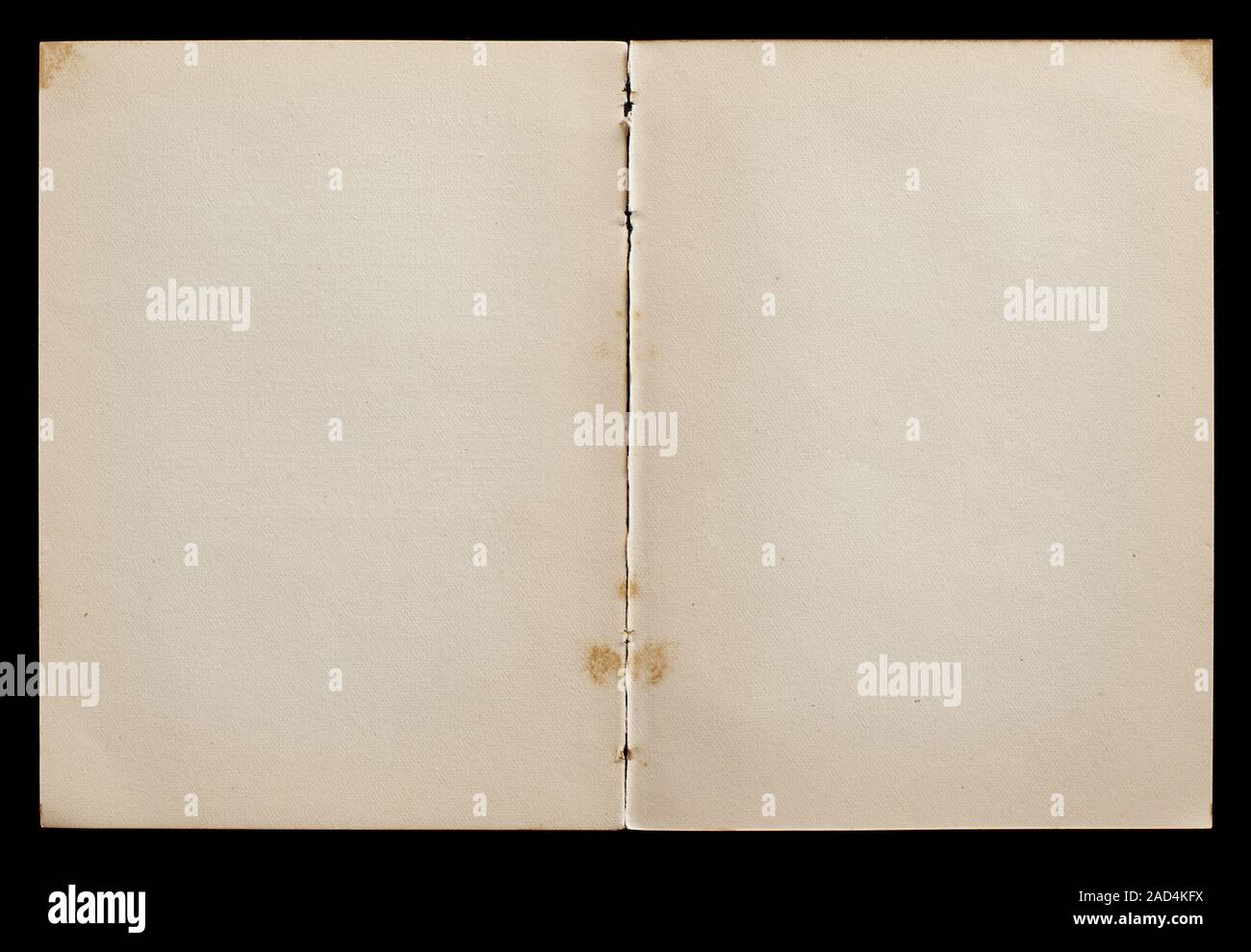 Antique book unfolded showing textured pages isolated on black ...