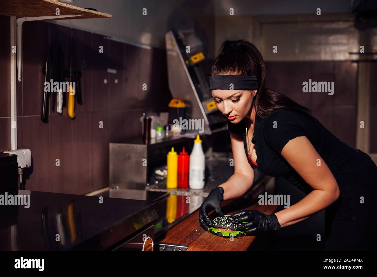 beautiful girl Cook prepares the kitchen Burger Stock Photo - Alamy