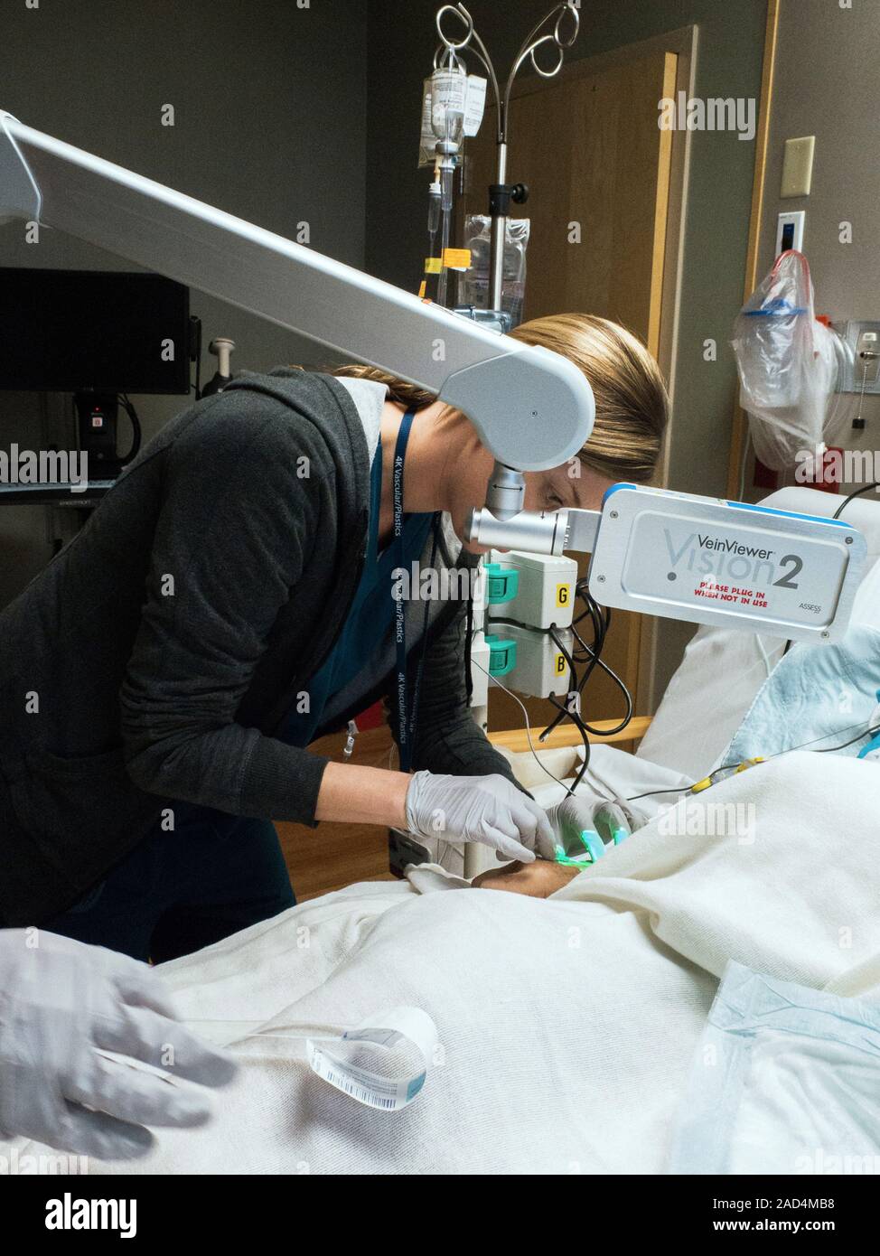 Nurse using infrared vein-finding device. Nurse using an infrared vein ...