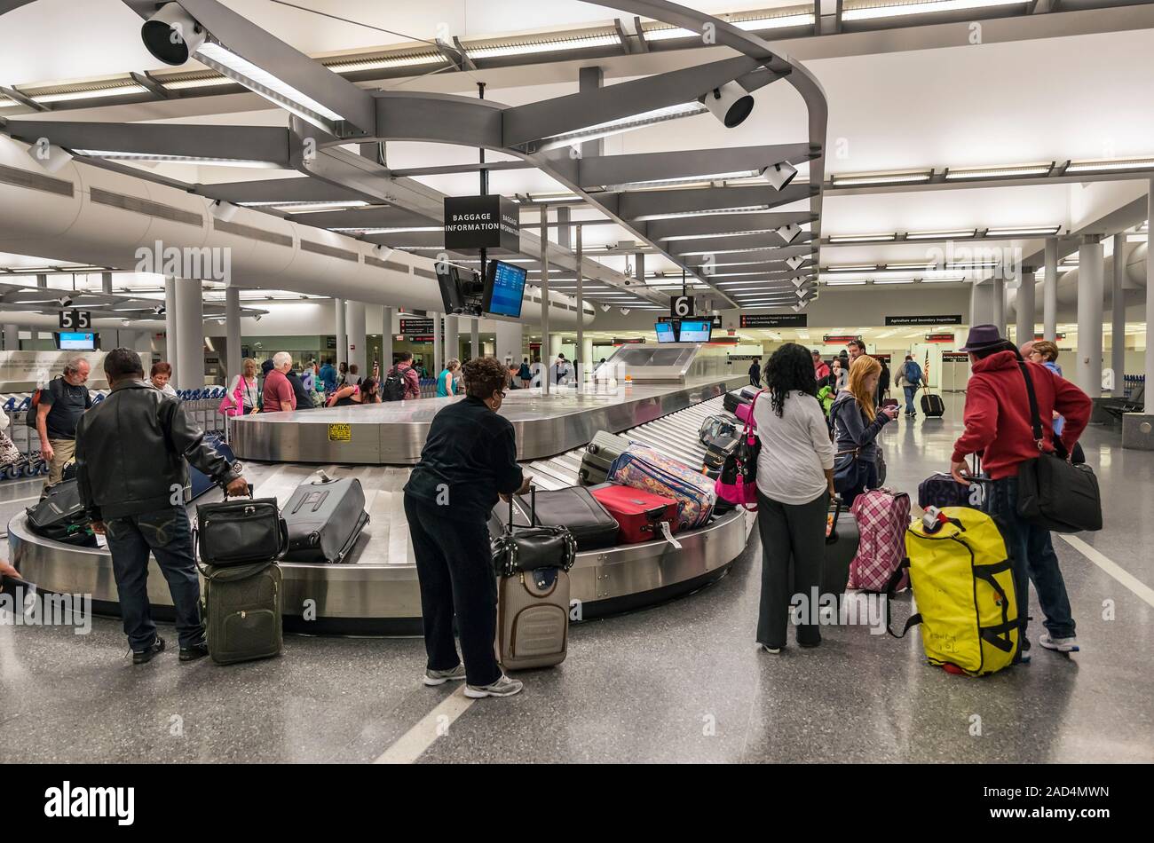 Philadelphia airport. People, collecting their luggage from a baggage ...